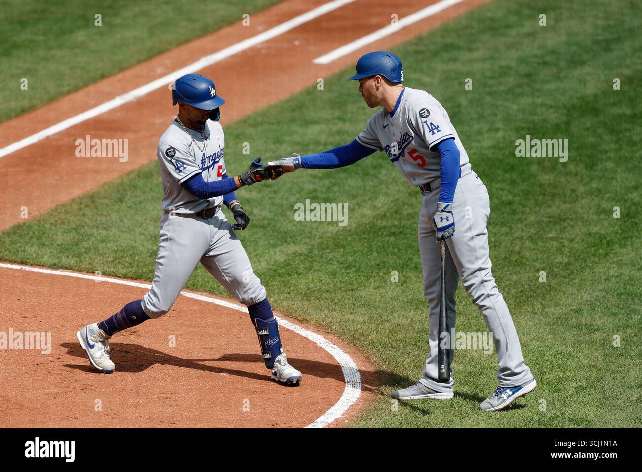 Los Angeles Dodgers' Mookie Betts, left, greets Freddie Freeman (5 ...