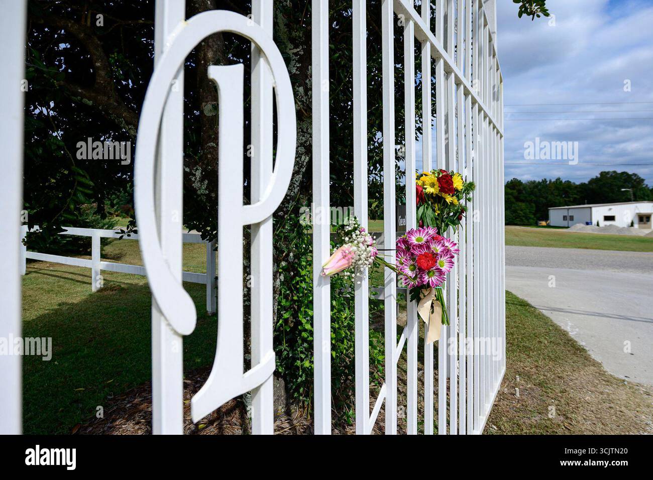 Flowers hang from the open gate of Kiesel Park in Auburn, Ala., as a ...