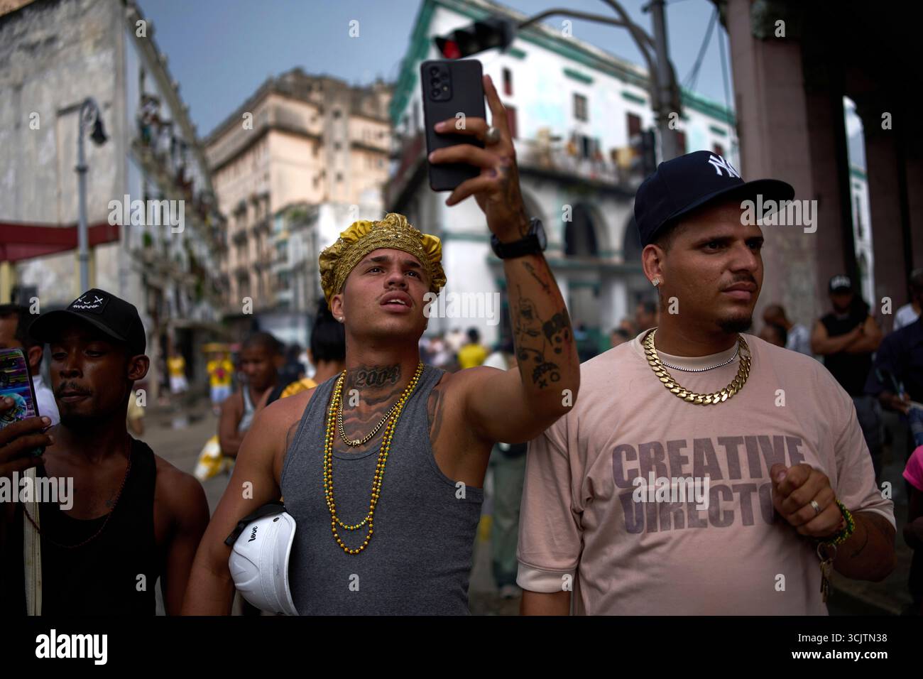 Faithful take pictures of a procession honoring the Virgin of Charity ...