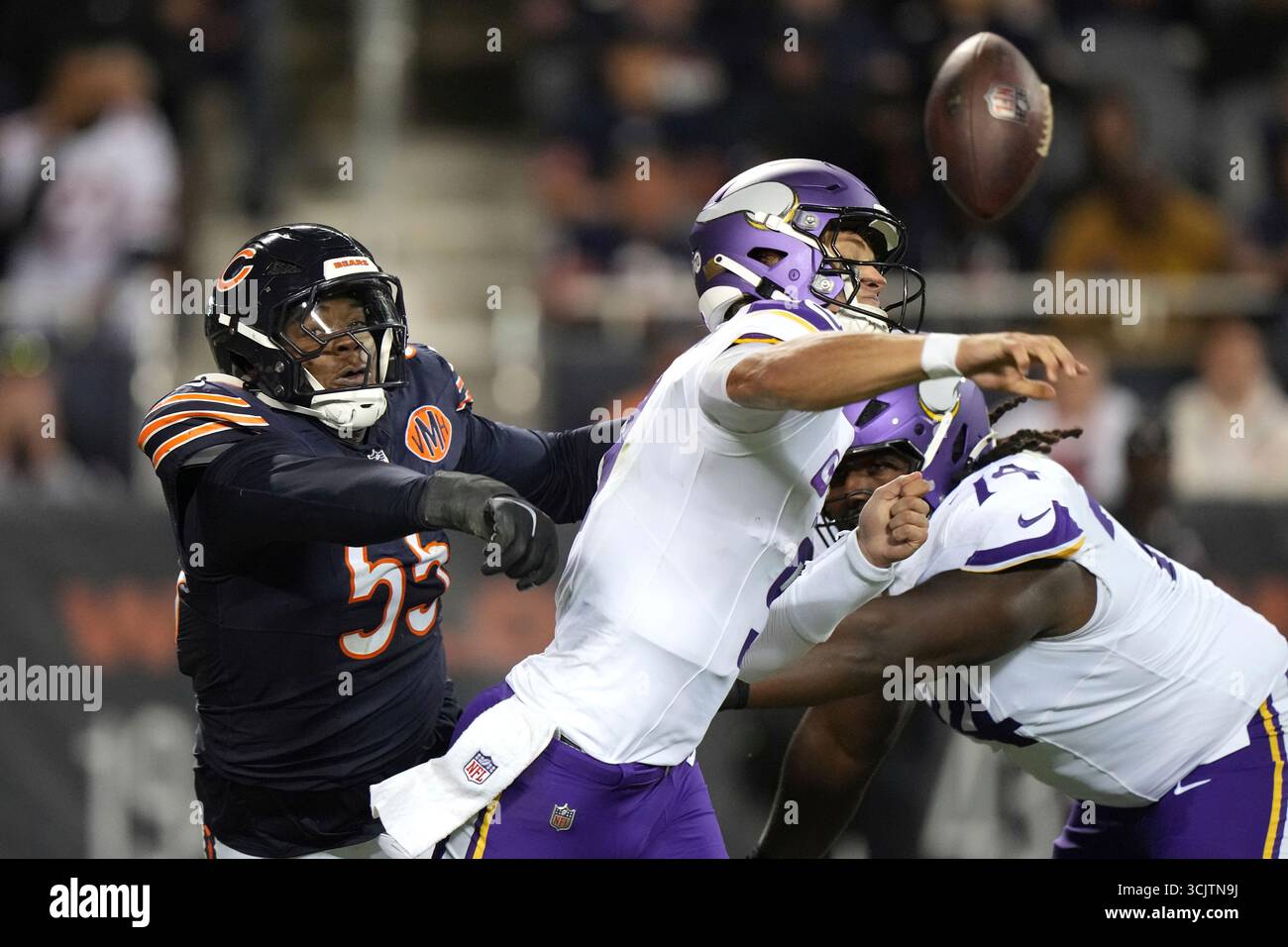 Minnesota Vikings quarterback J.J. McCarthy, right, has his arm hit by ...