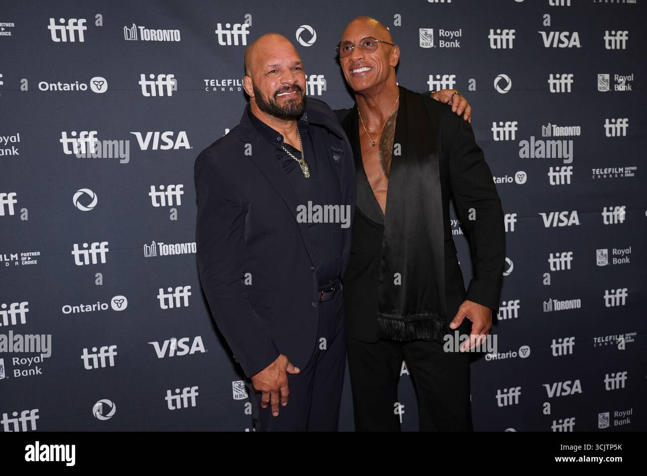 Mark Kerr, left, and Dwayne Johnson attend the premiere of "The Smashing Machine" at the ...