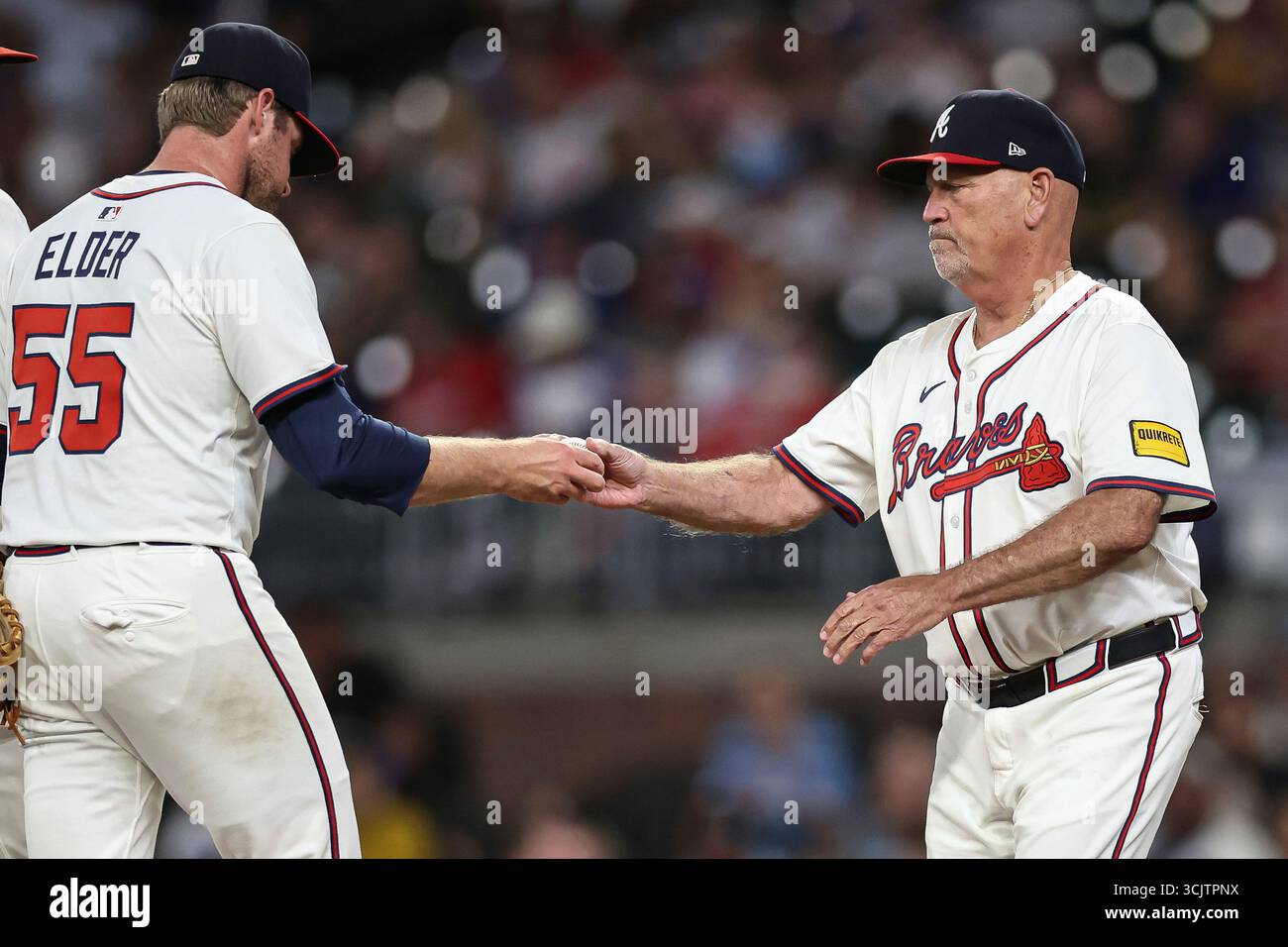 Atlanta Braves pitcher Bryce Elder (55) hands the ball to manager Brian Snitker, right, in the ...