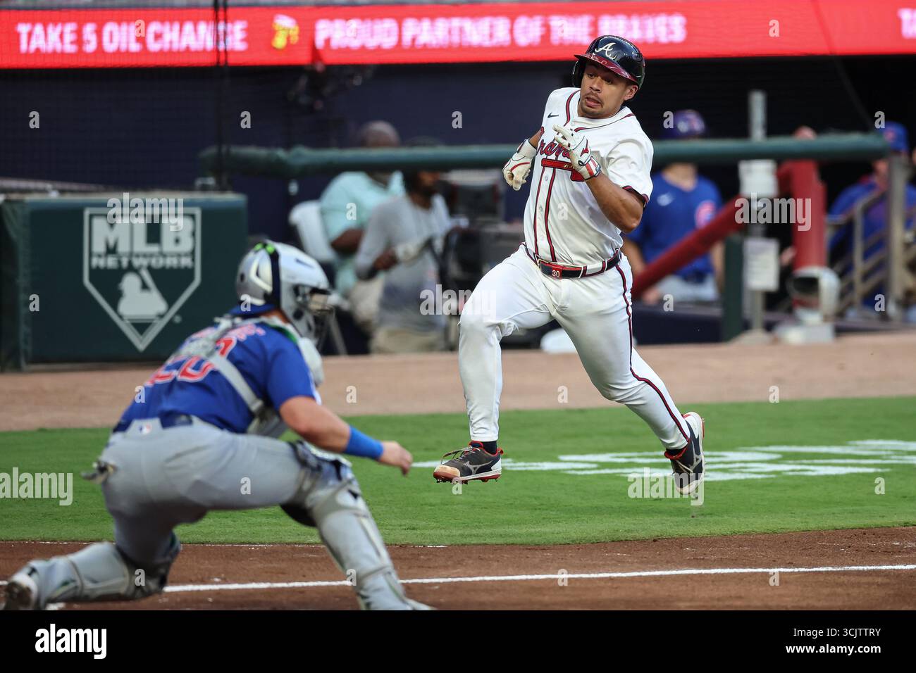Atlanta Braves' Drake Baldwin, right, runs home in the first inning of ...