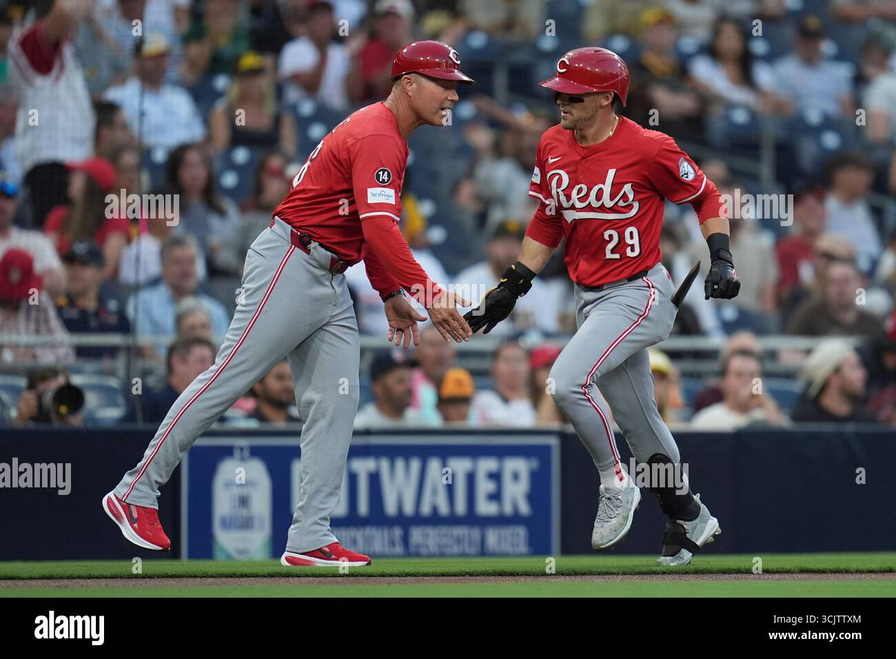 Cincinnati Reds' TJ Friedl, right, celebrates with third base coach J.R ...