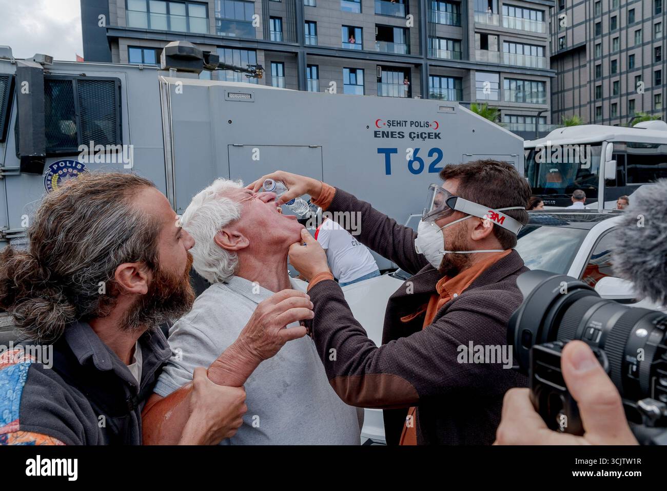 An elderly man is affected by pepper spray during the demonstration ...