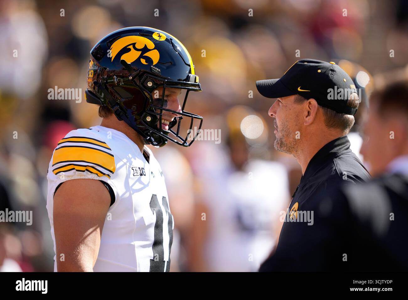 Iowa quarterback Mark Gronowski talks with offensive coordinator Tim ...