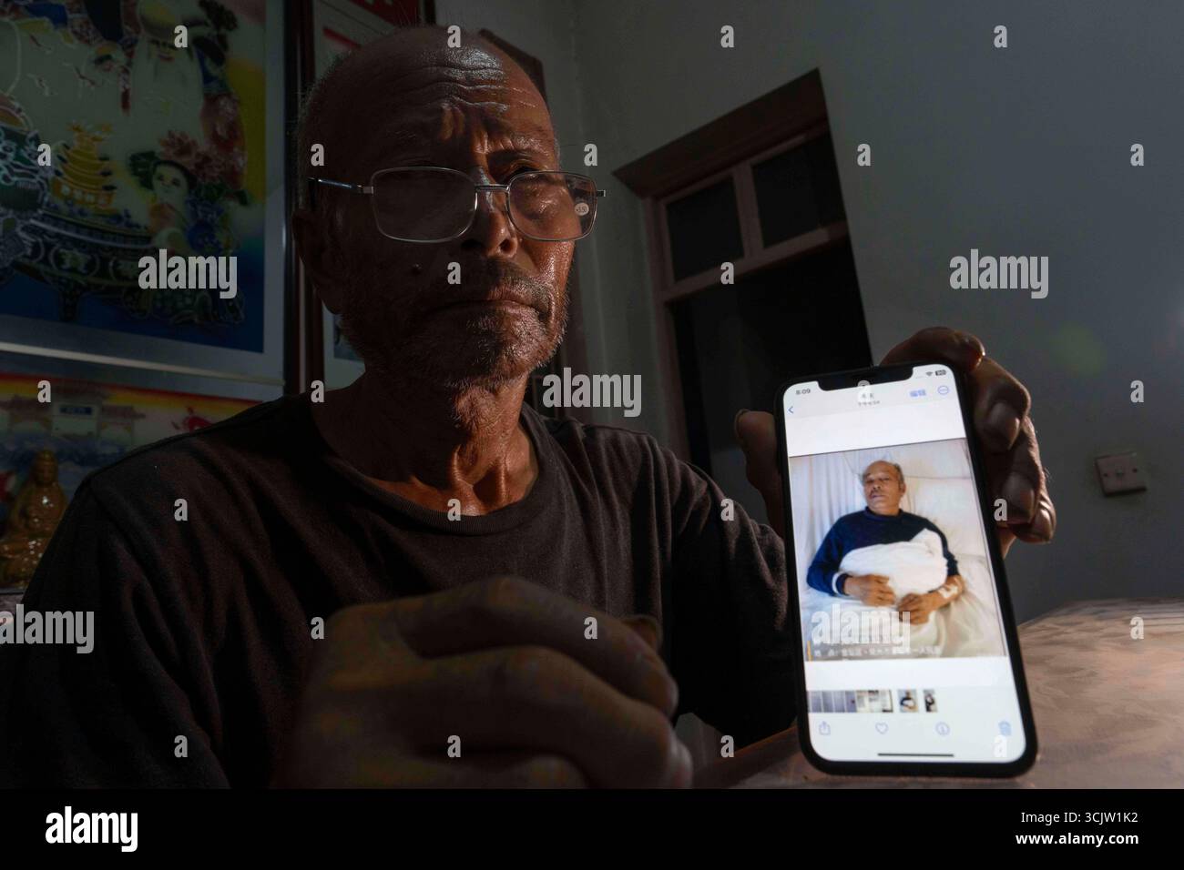 Yang Guoliang shows a March 12, 2024, photo of him lying in a hospital bed after police beat him ...