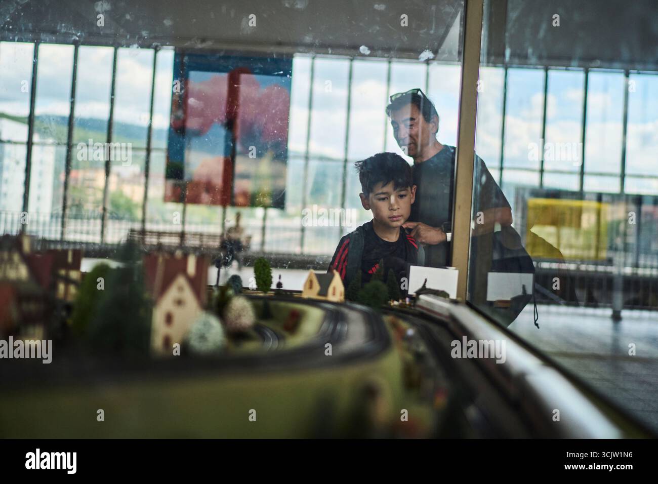 Former Xinjiang government engineer Nureli Abliz, rear, and his son ...