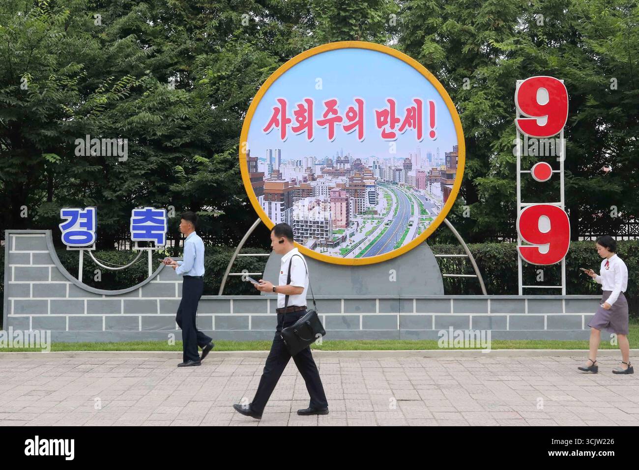 People walk in the street of Taedonggang District in Pyongyang, North ...