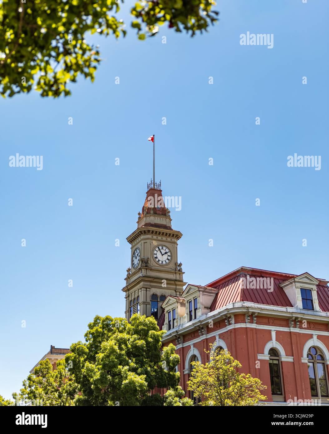 Historic red-brick building Victoria City Hall clock tower under a blue ...