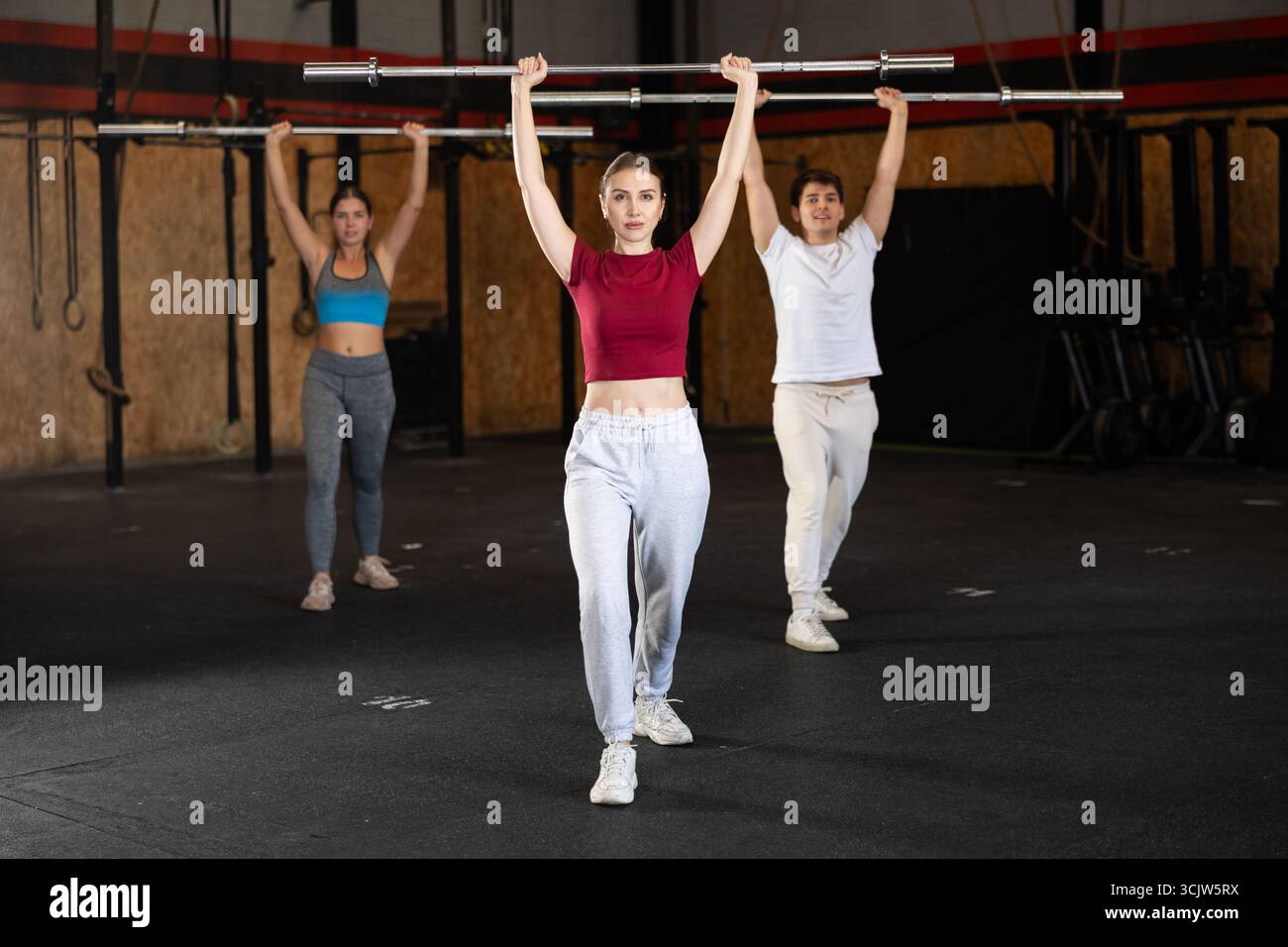Woman in training with a barbell Stock Photo - Alamy