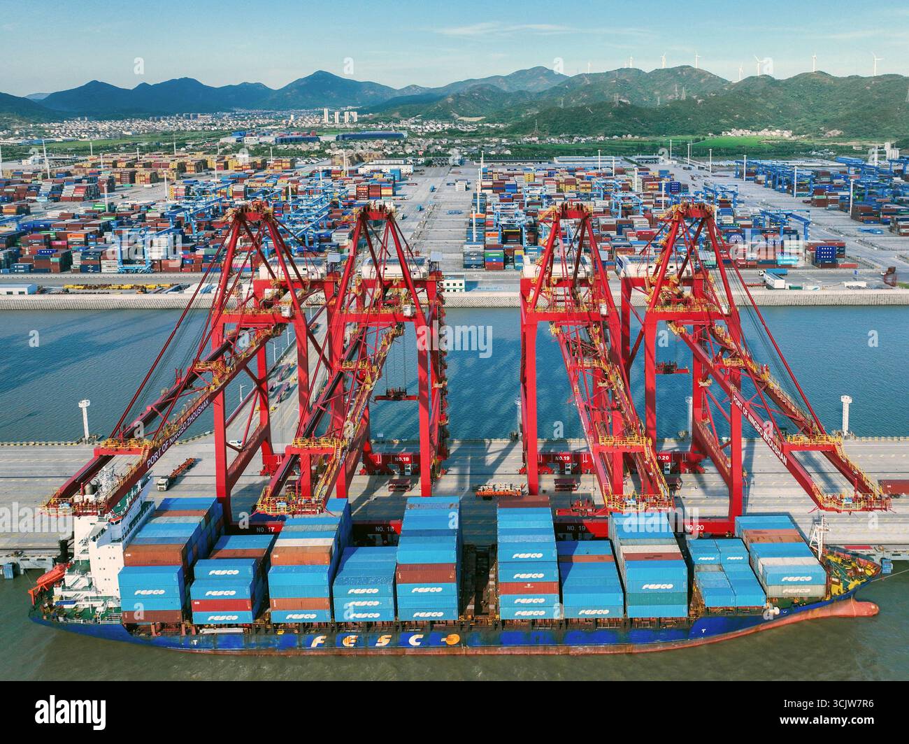 A cargo ship is loading and unloading containers in an orderly manner ...