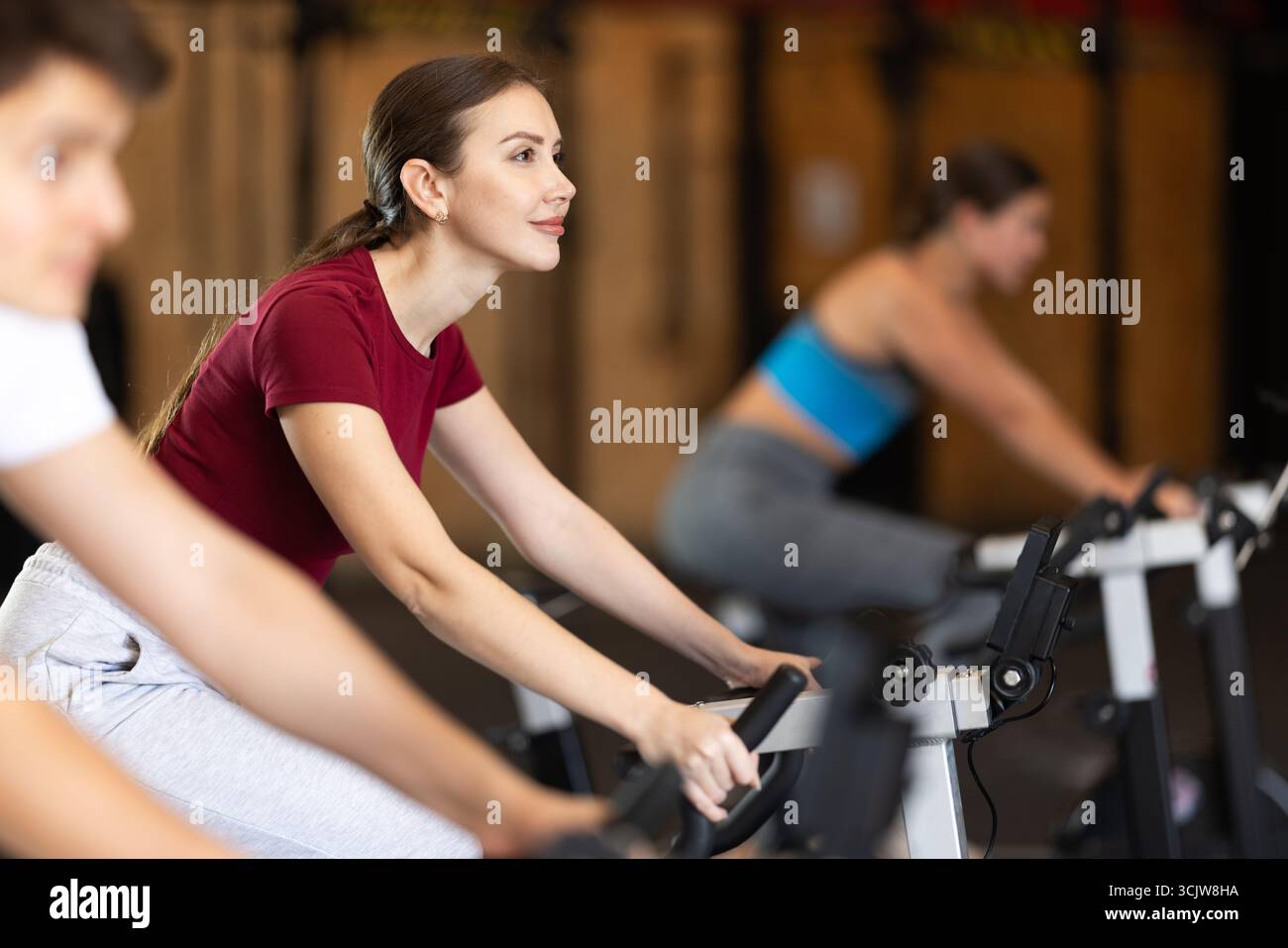Woman exercising on an exercise bike Stock Photo - Alamy