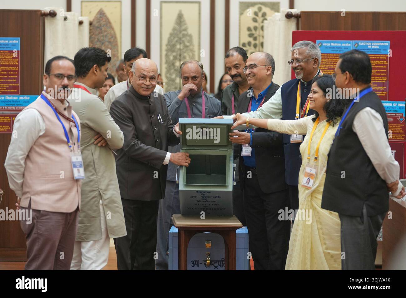 Election officials display empty ballot box before stating the process ...