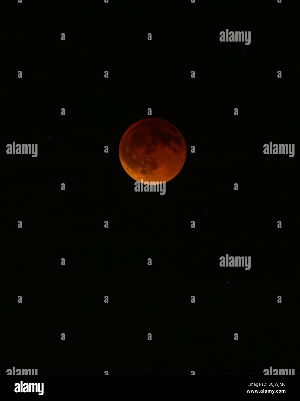 Aerial view of a blood moon glows with ethereal light against the inky ...