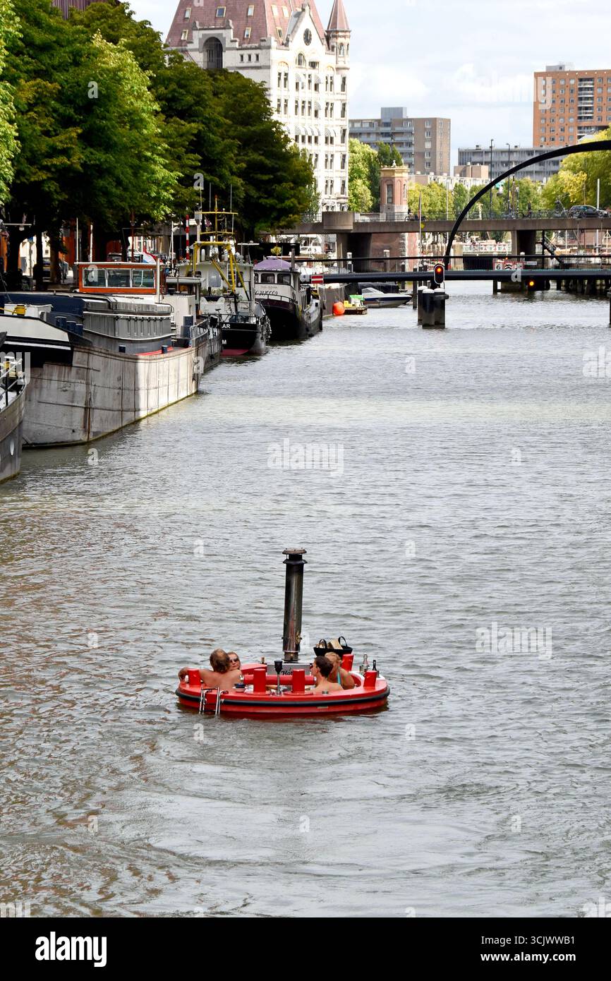 People in a floating wood fired hot tub sailing through Rotterdam ...