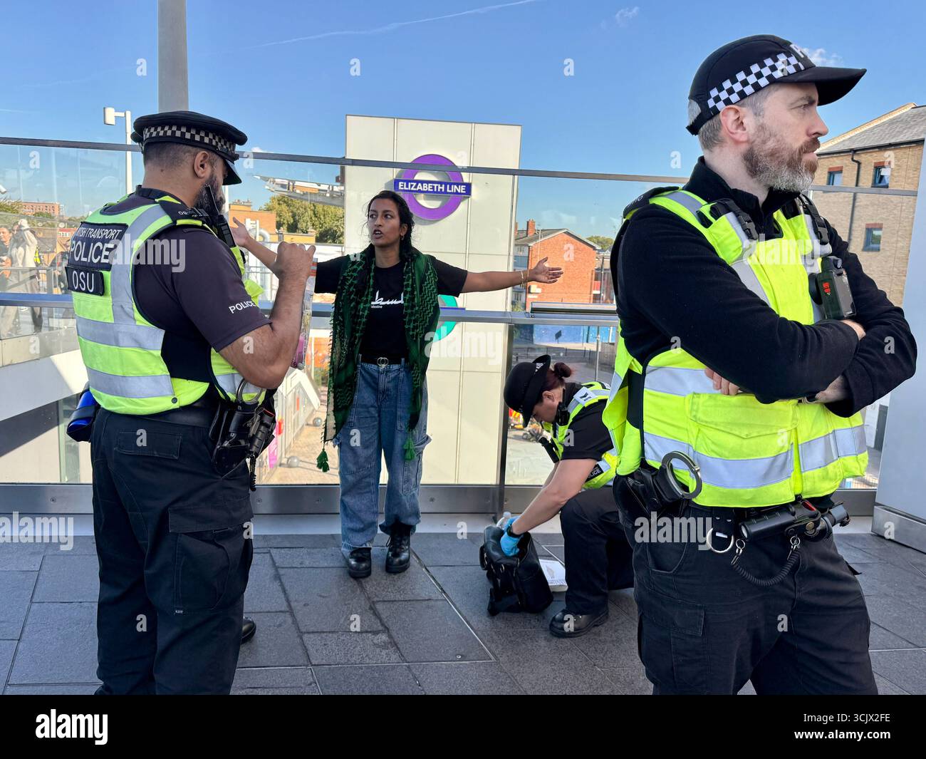 Police search a member of the public at Custom House DLR Station during ...