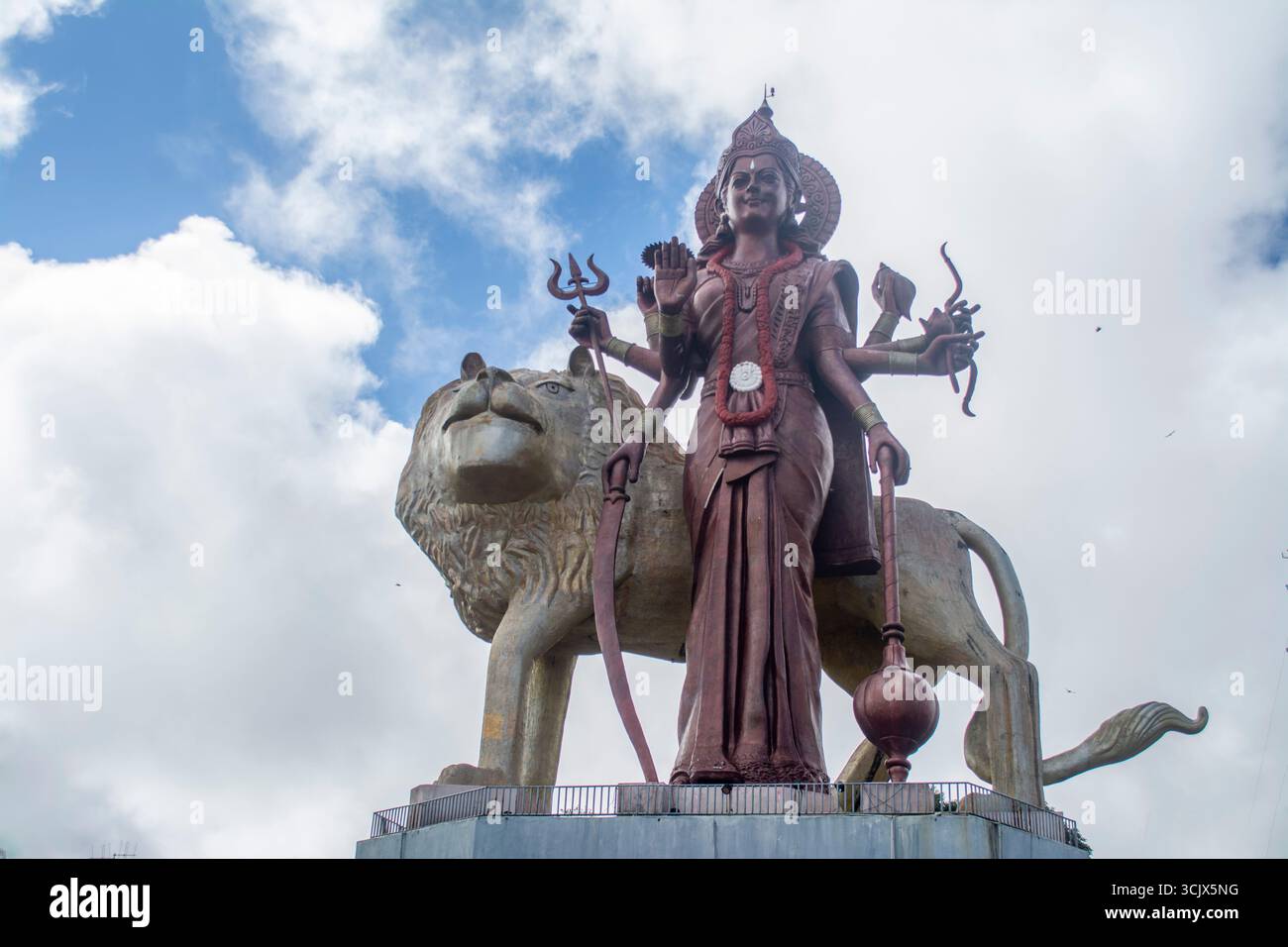 Statue of the Hindu goddess Durga Maa with a golden lion in sacred ...
