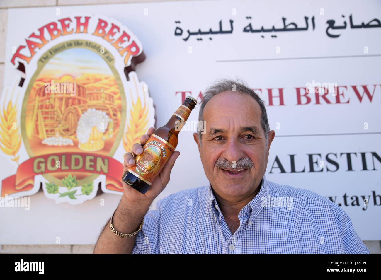 General Director Nadim Khoury shows a bottle of Taybeh beer at the ...