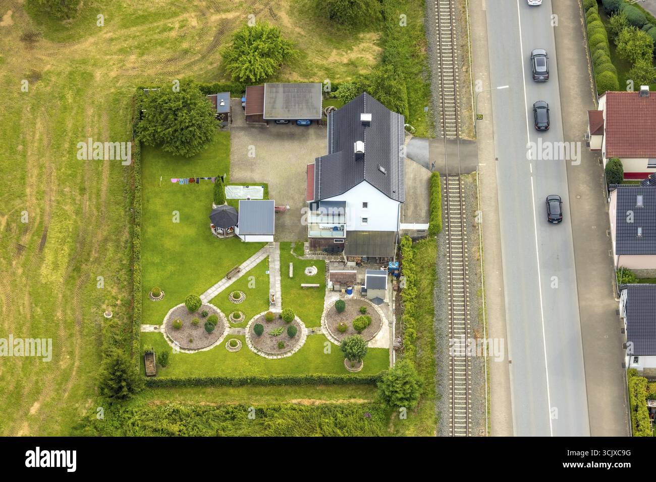 Aerial view, residential house on railway track with garden, federal ...