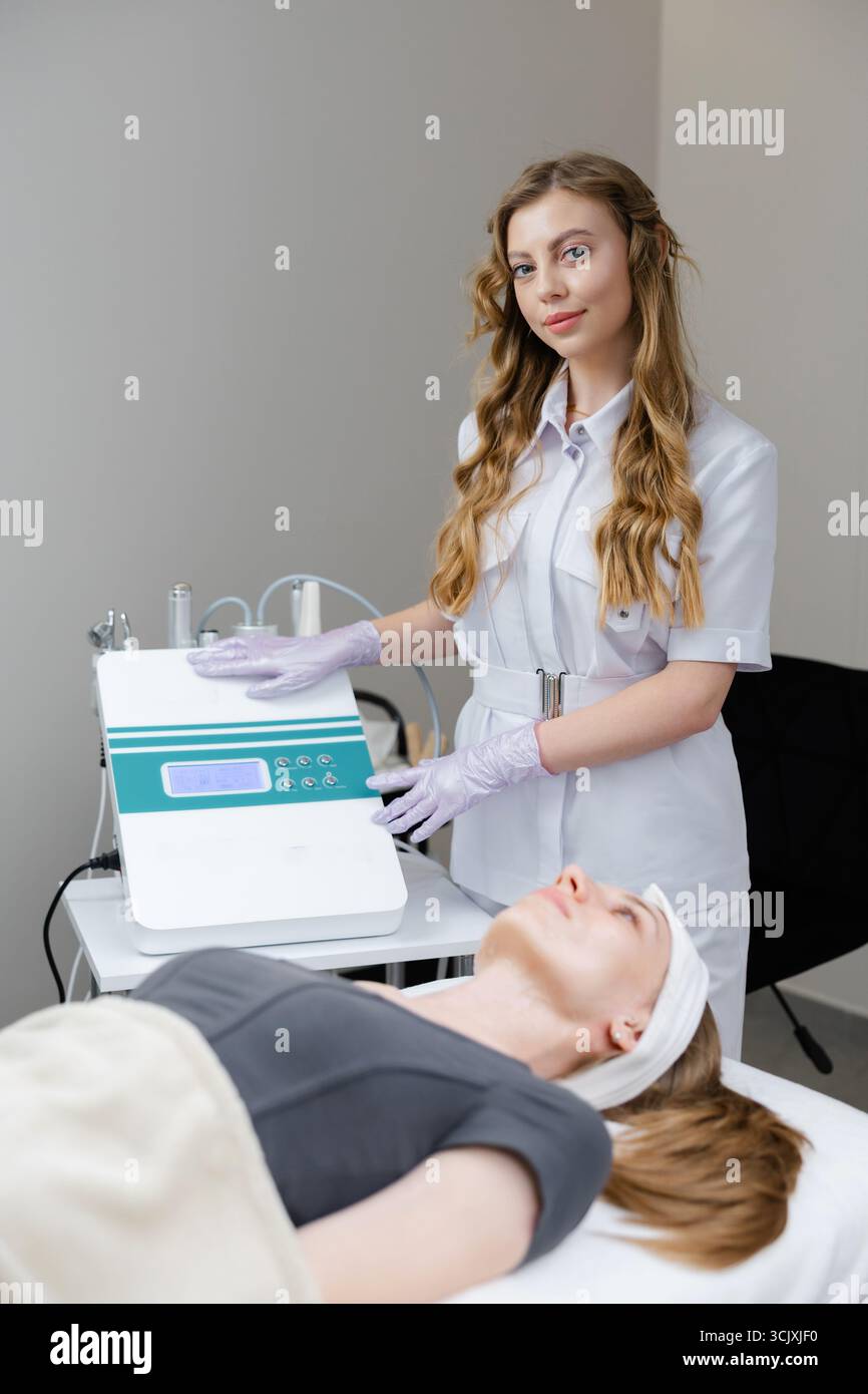 Professional aesthetician using advanced equipment hi-res stock ...