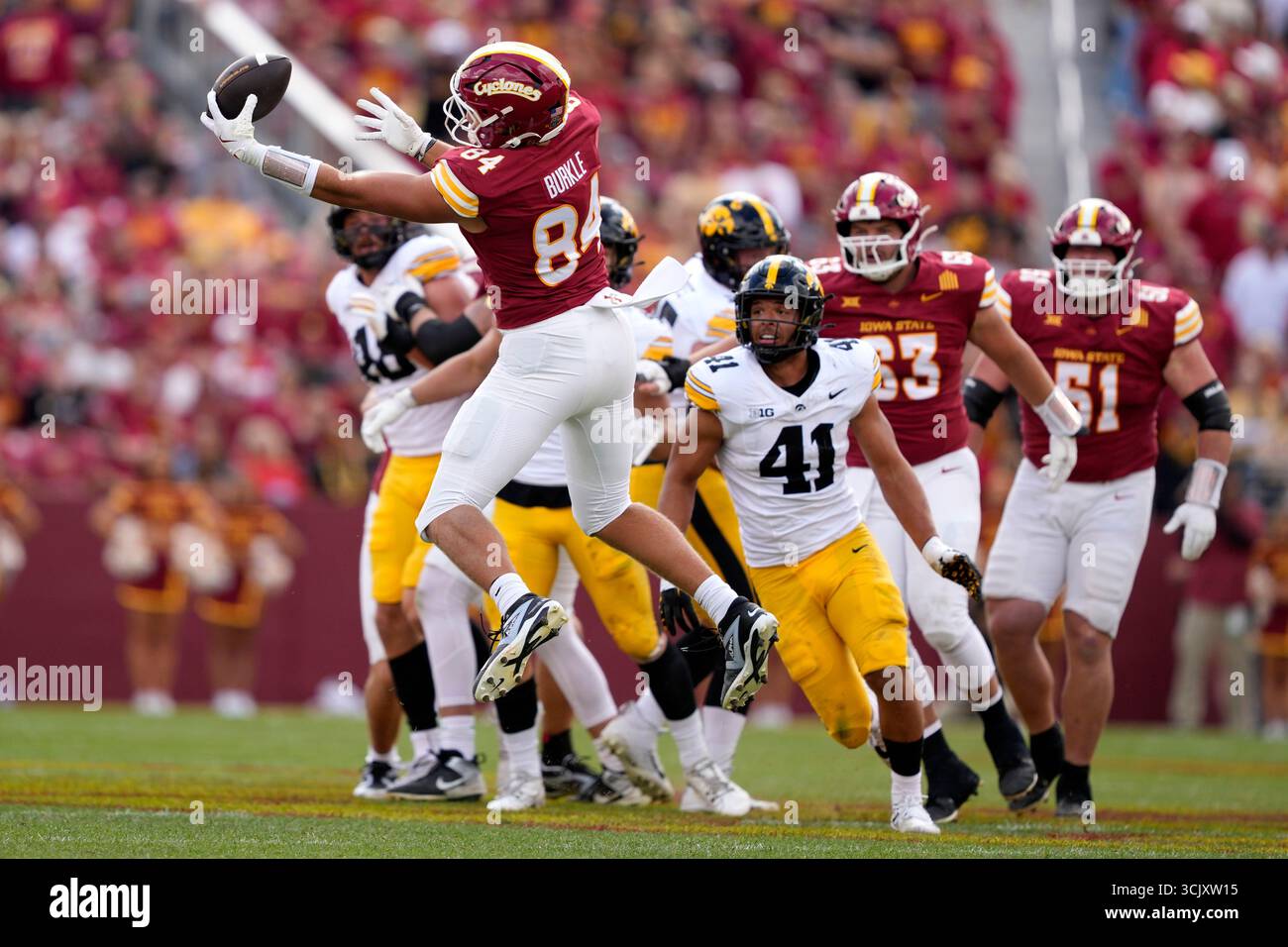 Iowa State tight end Gabe Burkle (84) catches a pass over Iowa linebacker Jaden Harrell (41 ...