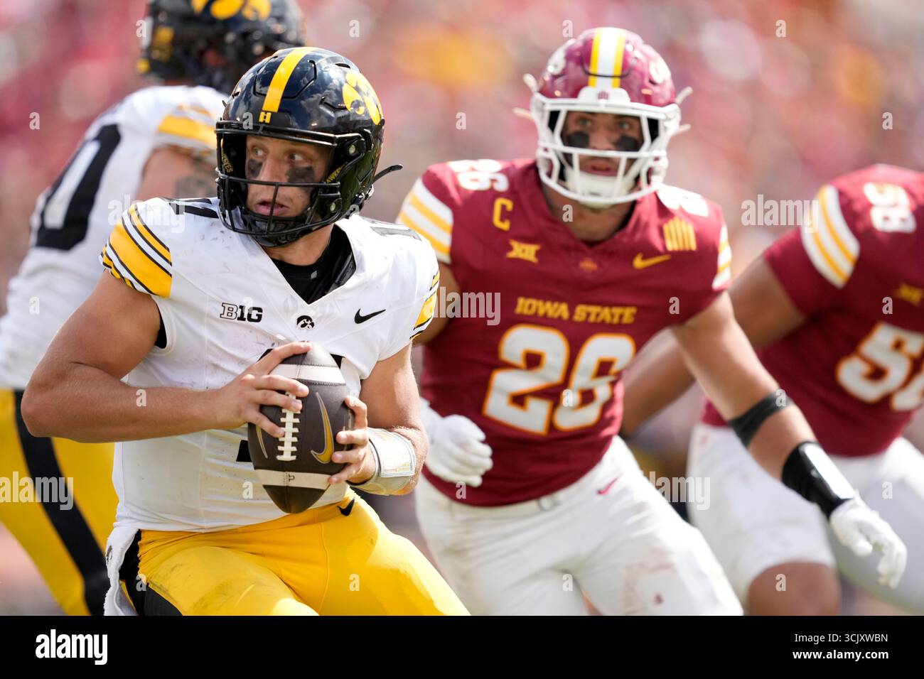 Iowa quarterback Mark Gronowski (11) runs from Iowa State linebacker ...