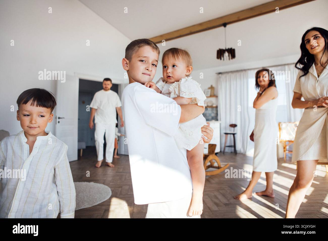 Family members, including children and adults, are interacting in a ...