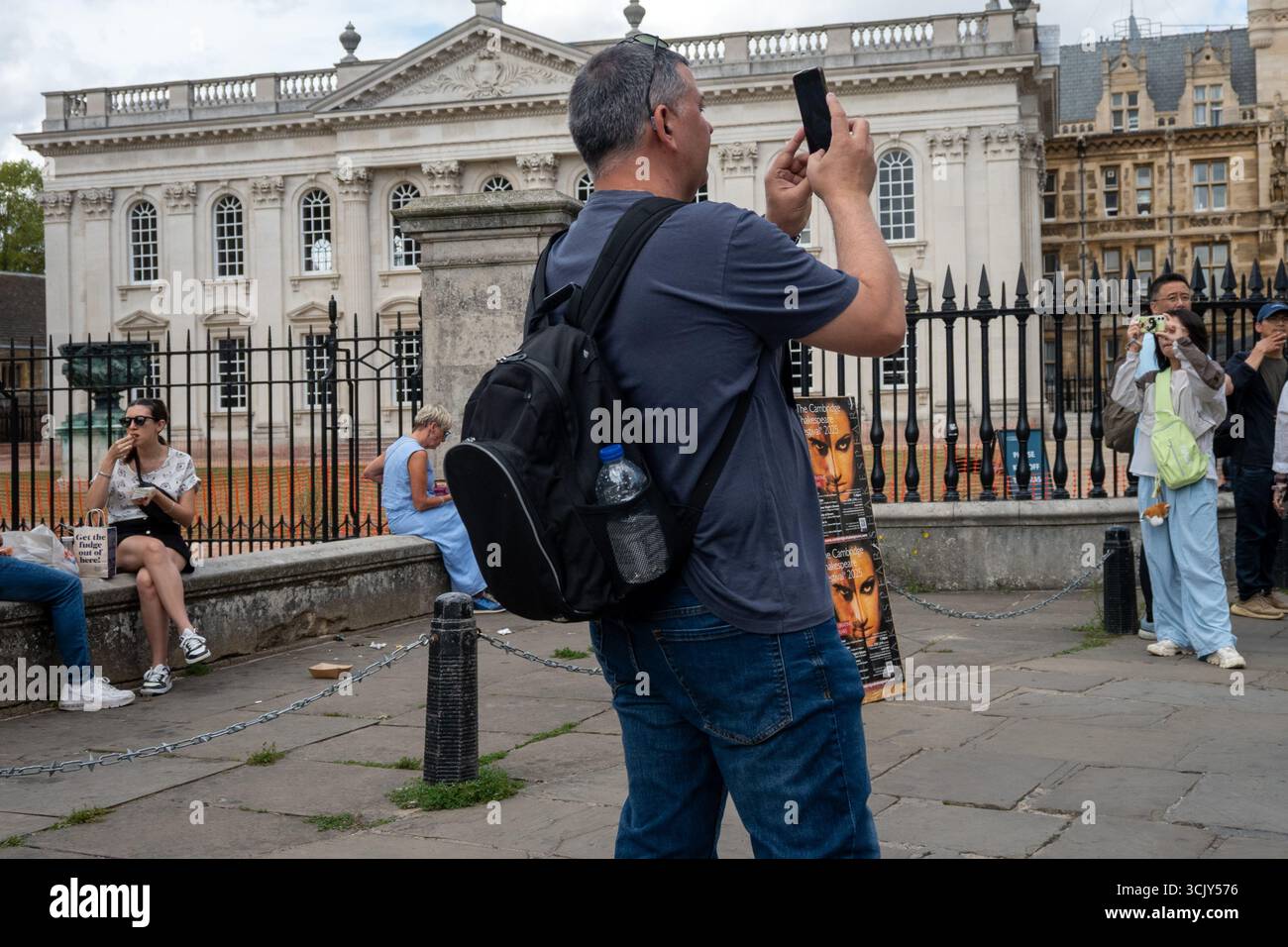 Tourists explore historic Cambridge, England, with King's College Chapel in the background on a ...
