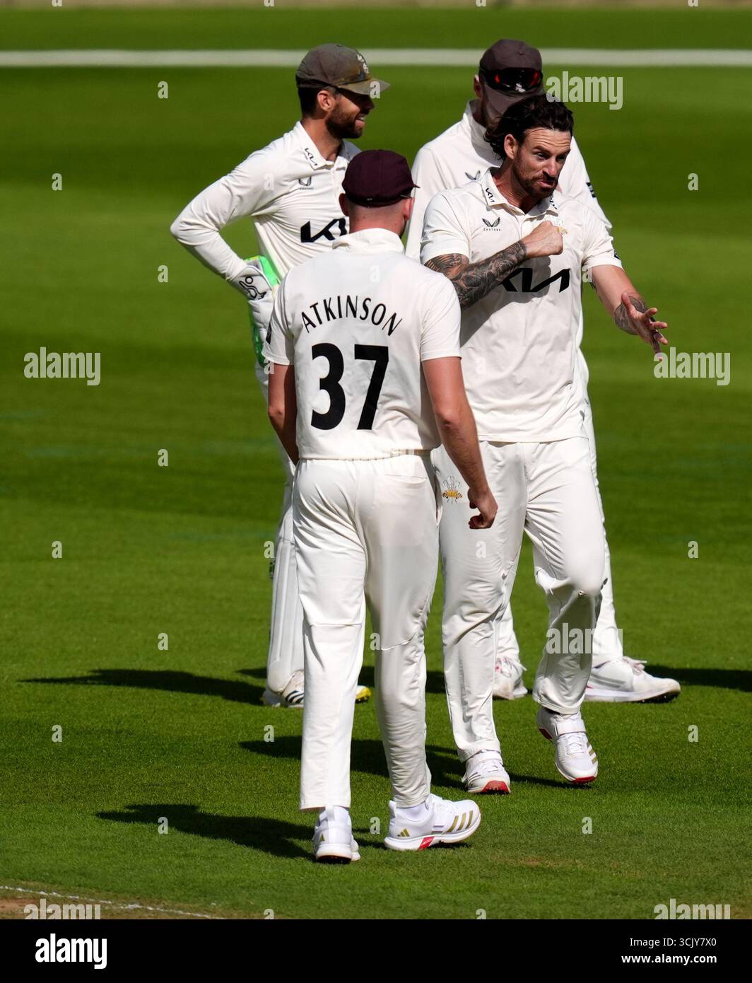 Surrey’s Jordan Clark (right) celebrates taking the wicket of ...