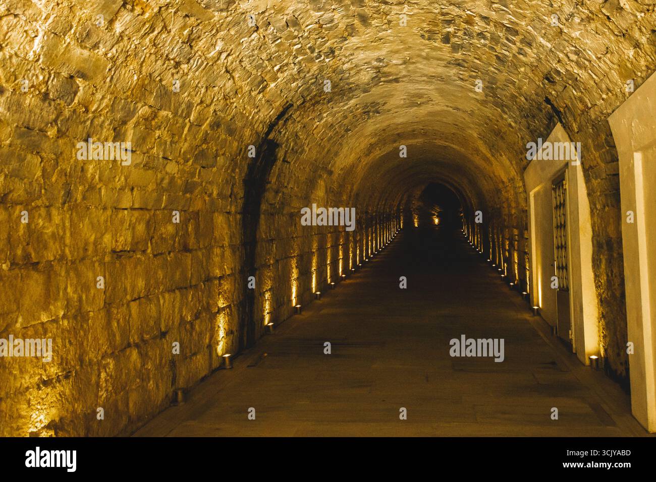 Illuminated underground stone tunnel of Panathenaic Stadium Kalimarmaro ...
