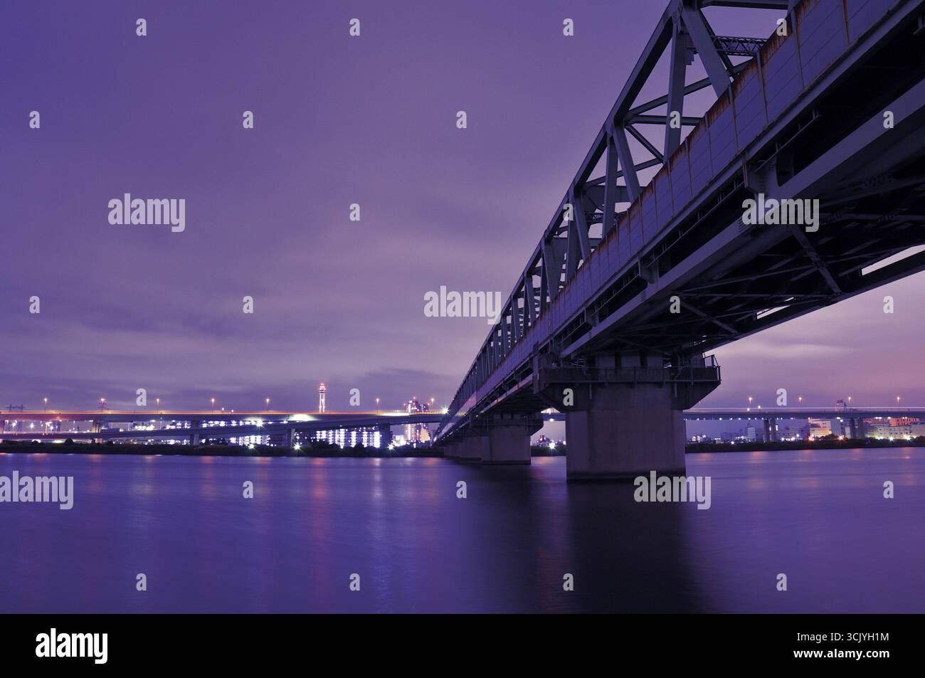 Huge metallic railroad bridge over Arakawa river waters in Tokyo, Japan ...
