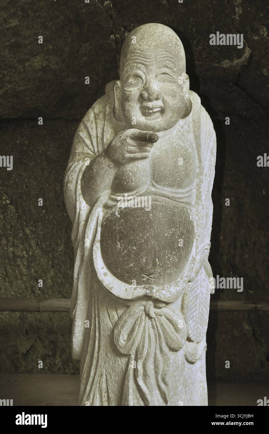 Sculpture of Japanese god Hotei at Jochiji Temple in Kamakura. Hotei is ...