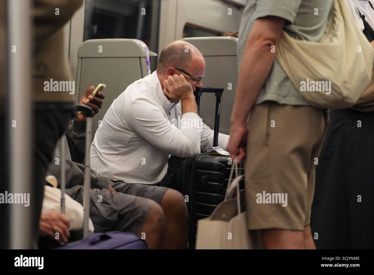 Passengers on an eastbound Elizabeth Line train from Heathrow Airport ...