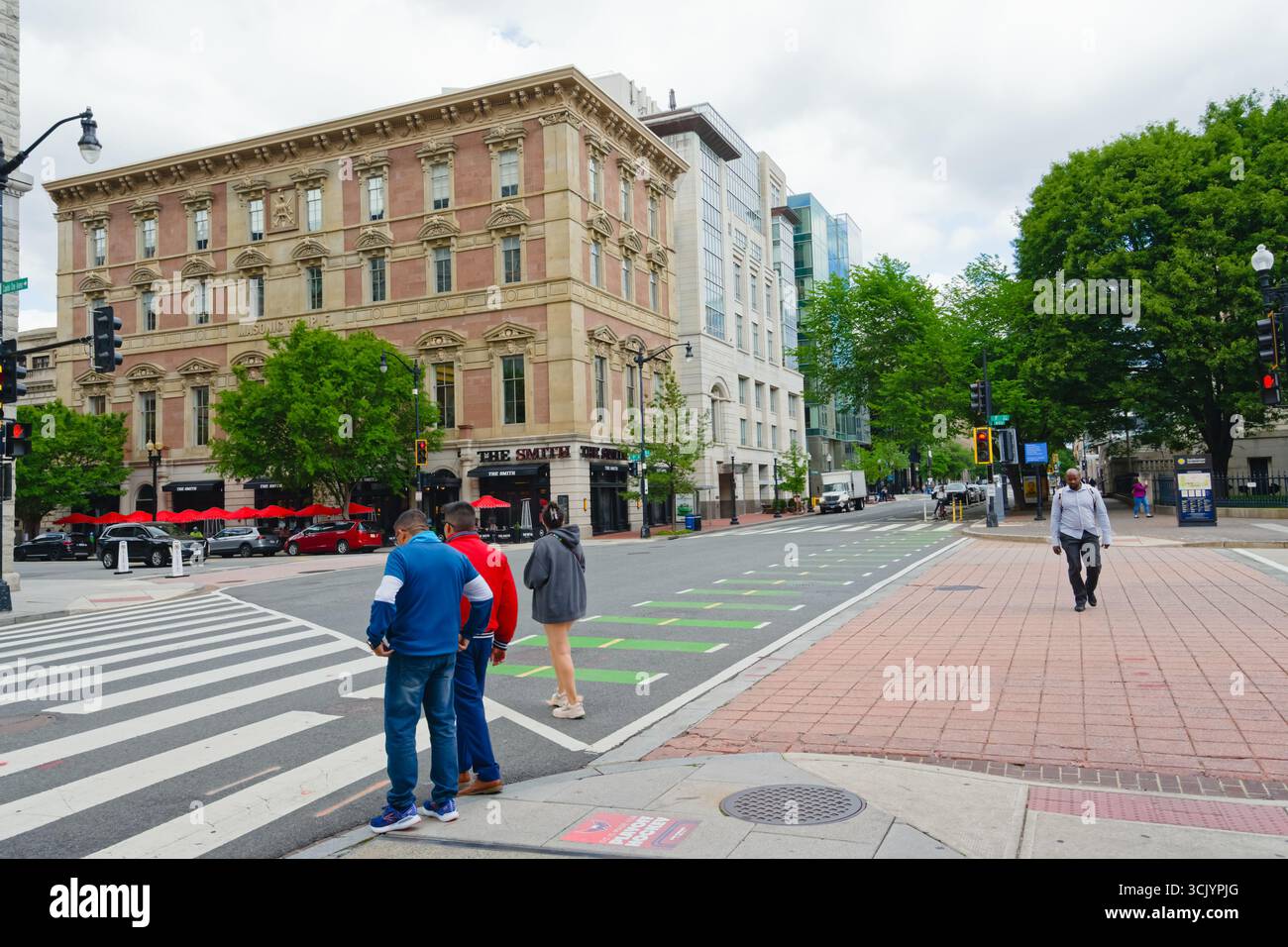 Washington D.C., USA - May 24, 2025. People cross a busy intersection ...