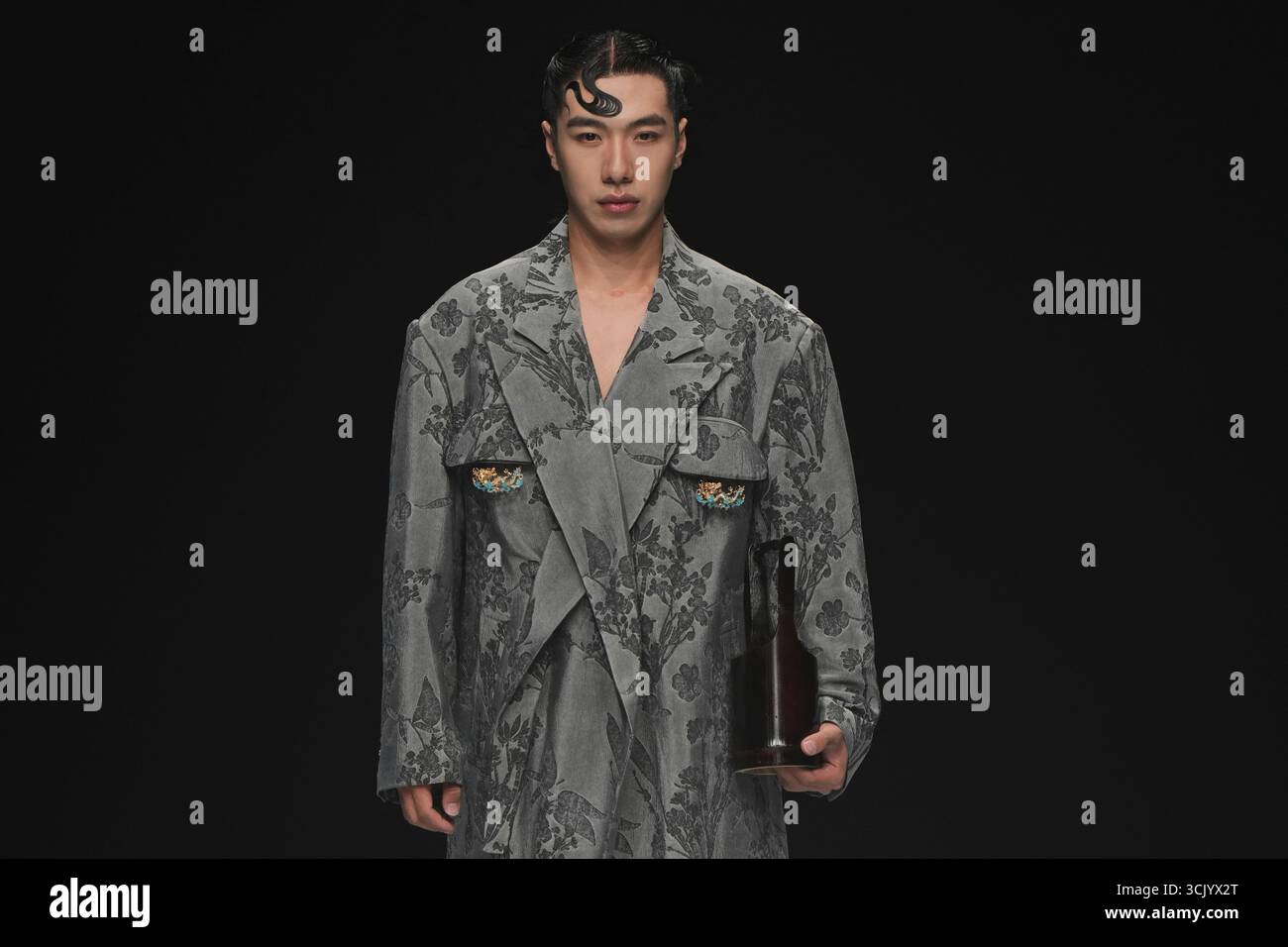 A model presents a creation from the DongfangJibai collection by Xu ...