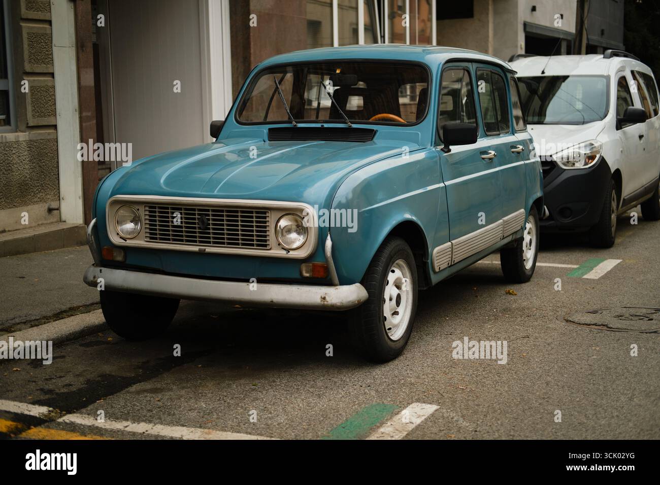 Vintage blue Renault parked in Belgrade street, old model car in front ...