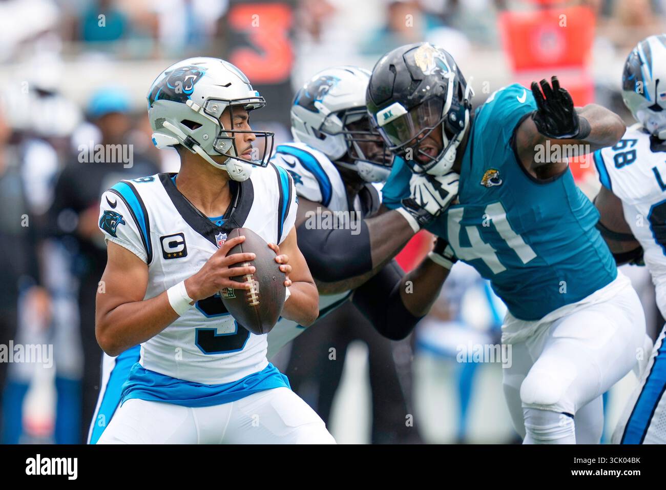 Carolina Panthers quarterback Bryce Young, left, looks for a receiver ...