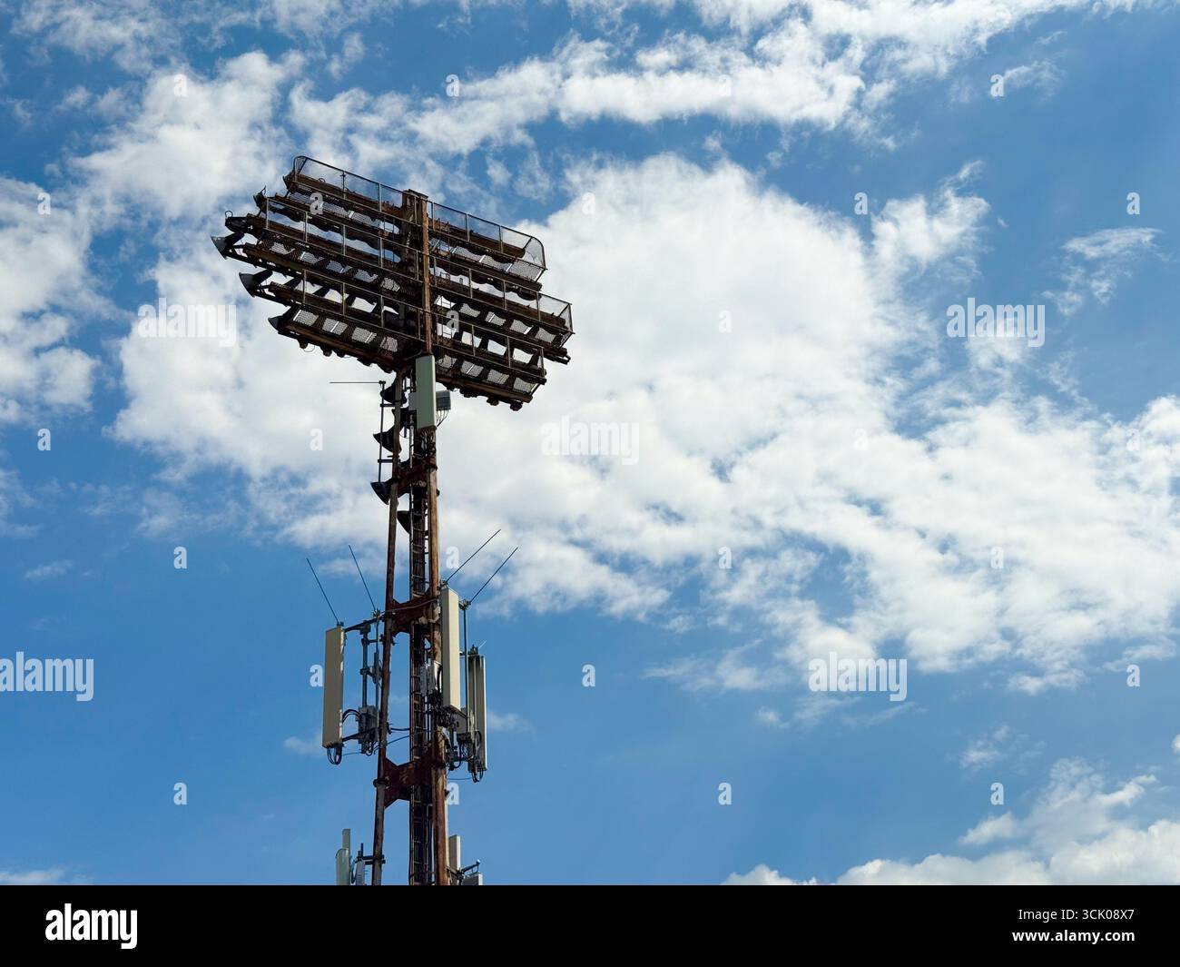 Tall floodlight tower with antennas and lamps at Belgrade stadium under ...
