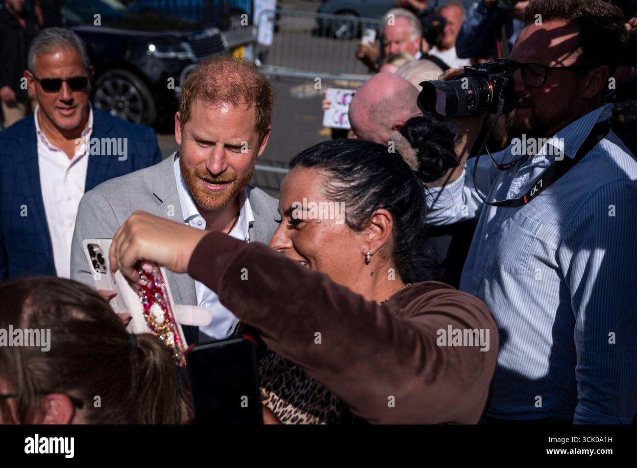 The Duke of Sussex greets members of the public following a visit to ...