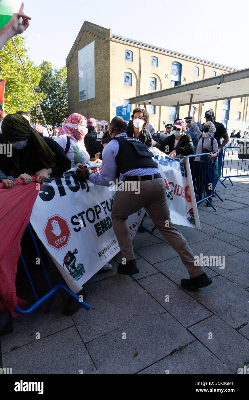 Security Guards use barriers to push back protesters at the DSEI Arms ...