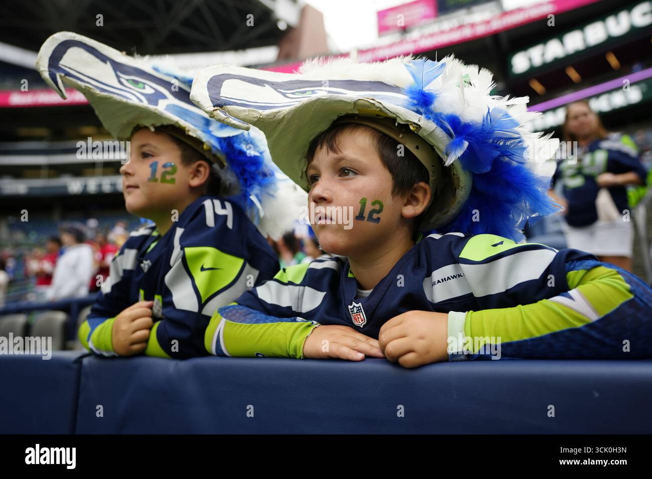 Seattle Seahawks fans look on before an NFL football game against the ...