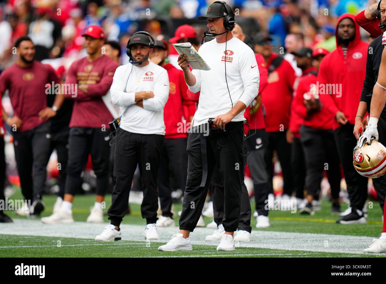 San Francisco 49ers head coach Kyle Shanahan looks on while wearing a ...