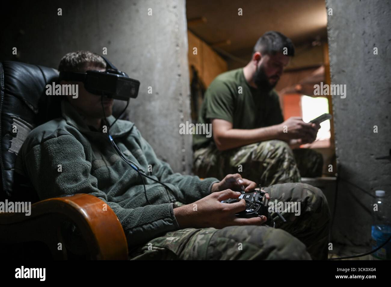 A Ukrainian servicemember wears a pair of electronic goggles as he ...