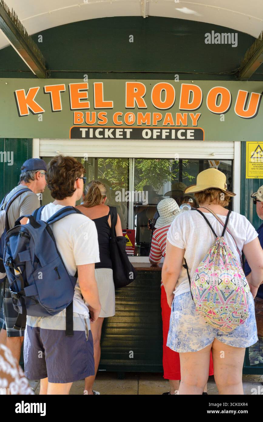 People queuing at Ktel bus station ticket office, Rhodes Town, Greece ...