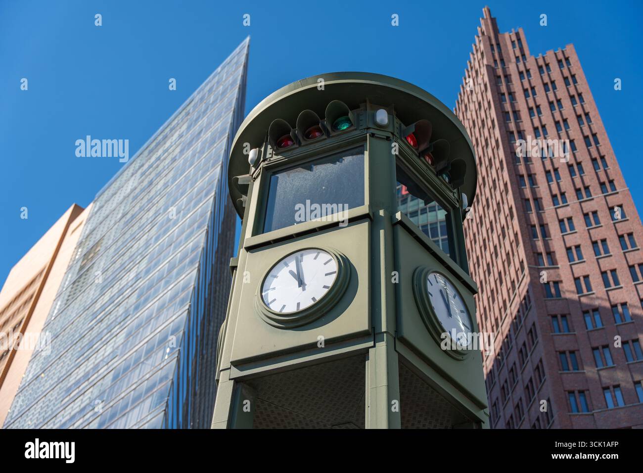 Historic clock tower at Potsdamer Platz with a clock and traffic lights ...