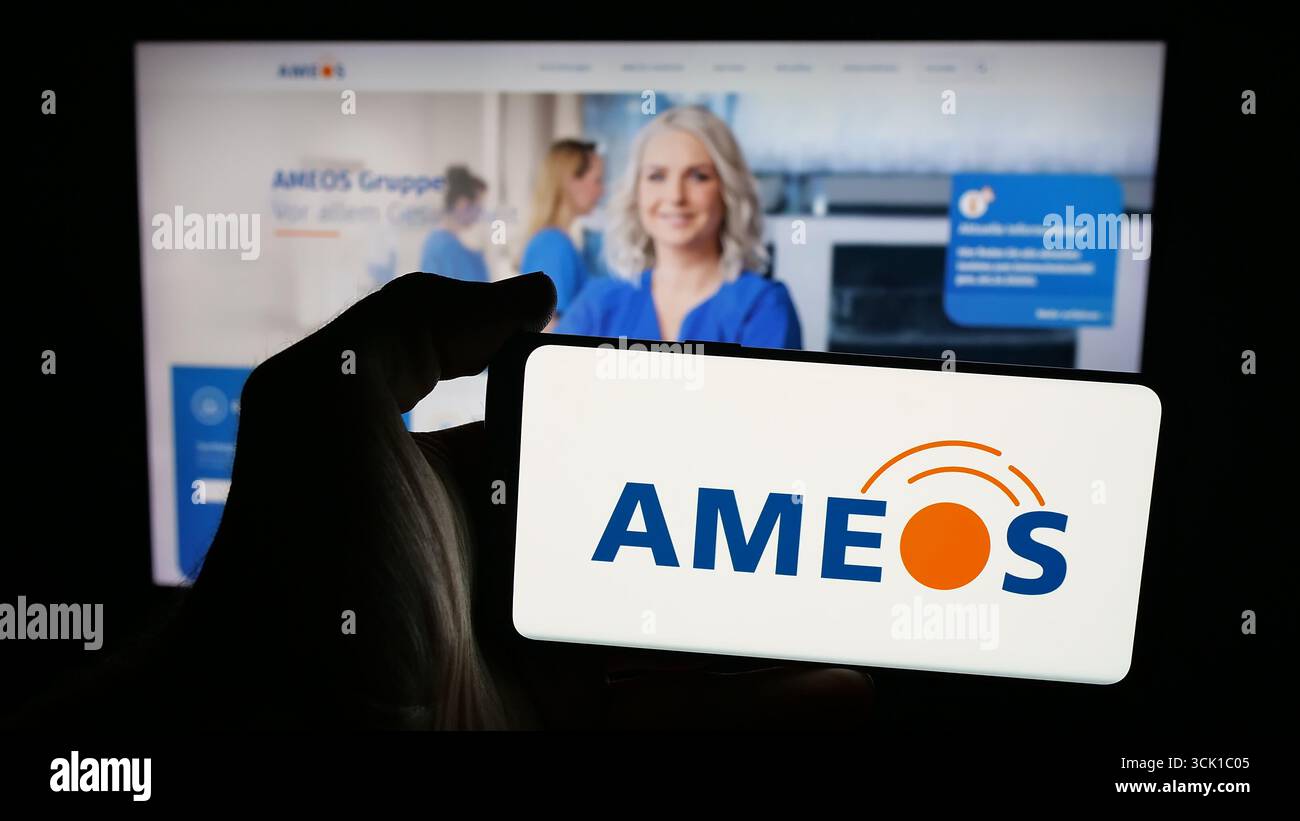 In this photo illustration, a person is holding a mobile phone with the ...