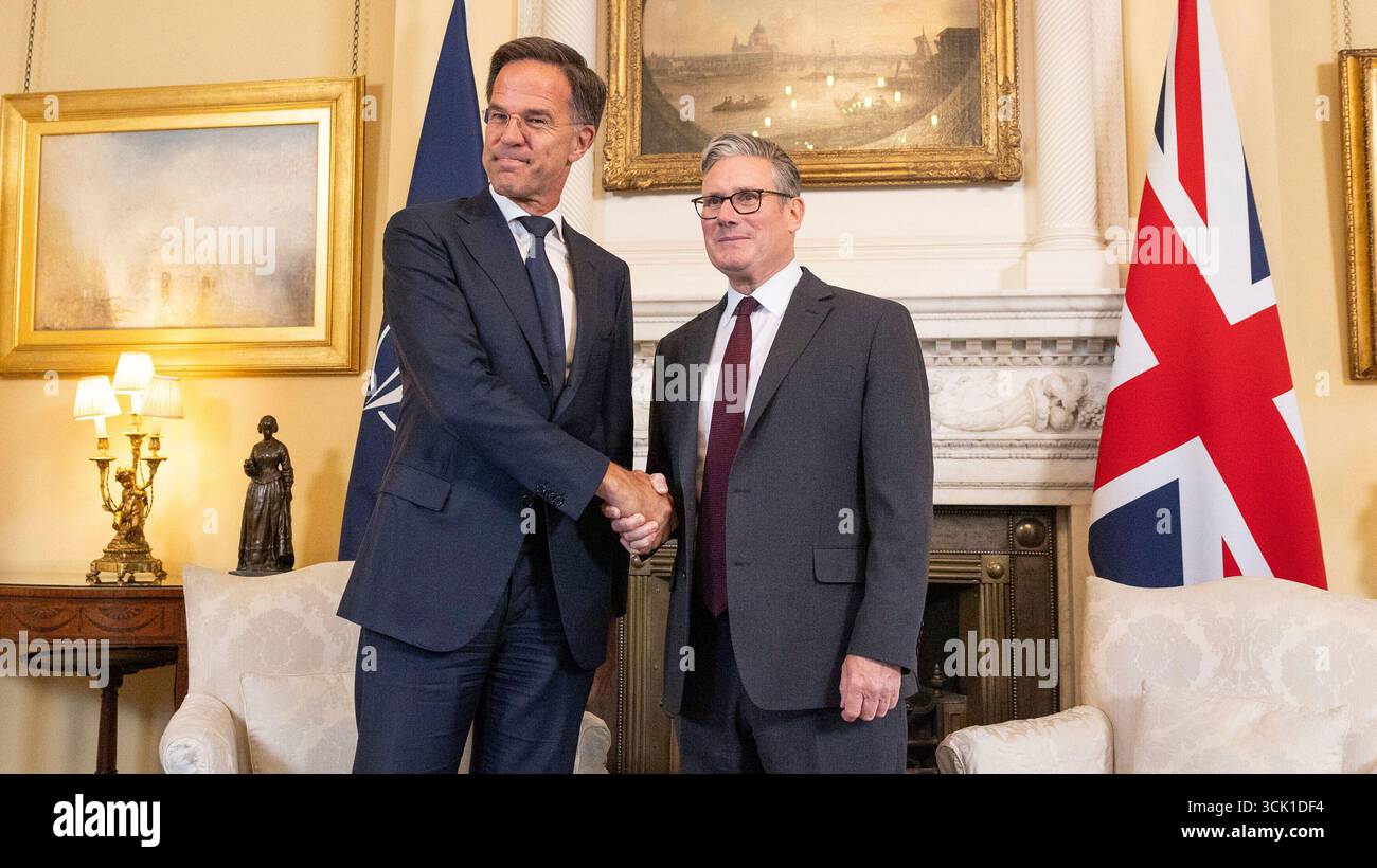 Britain's Prime Minister Sir Keir Starmer, right, greets NATO Secretary ...