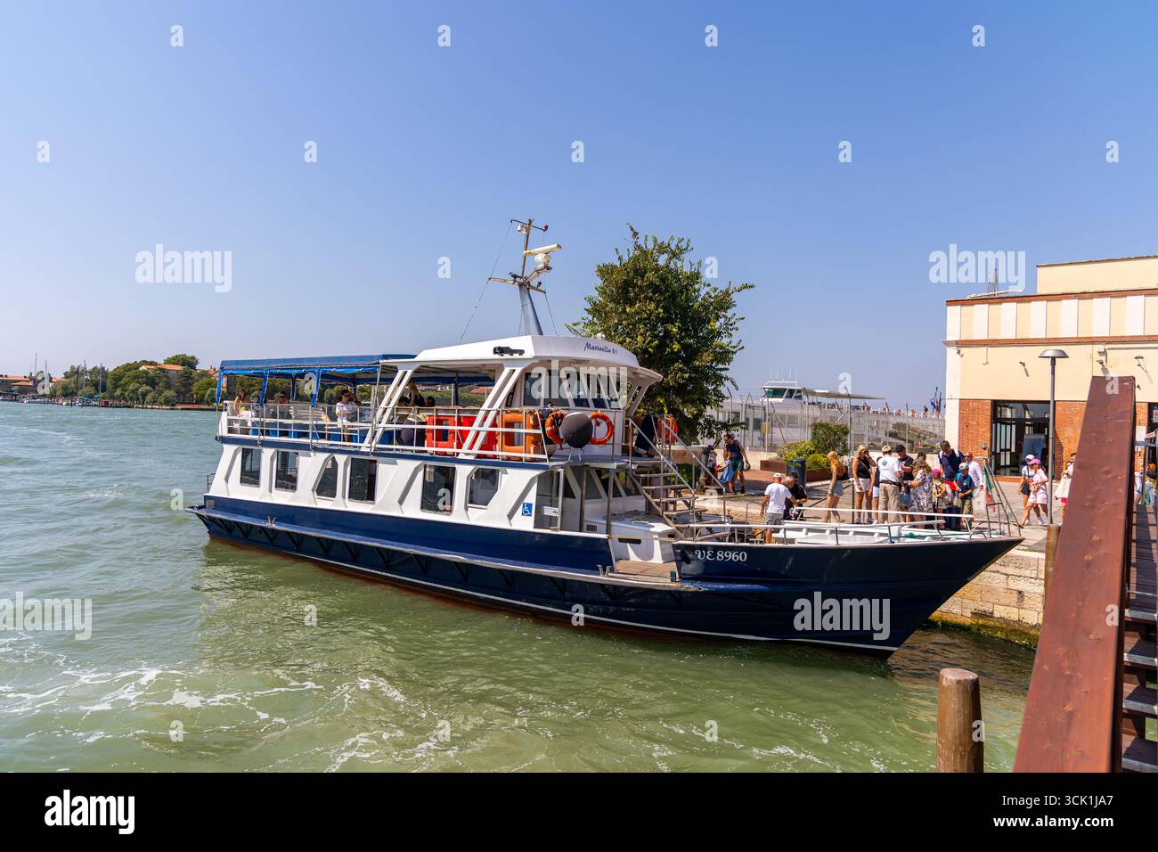 Venice, Italy, August 11, 2025: Tour boat docked at Venice island pier ...