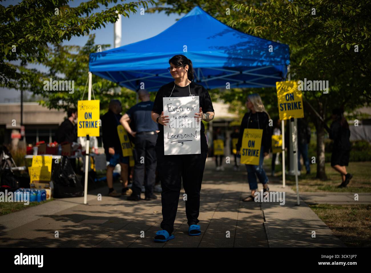 Members of the BC General Employees' Union picket outside of the Surrey ...